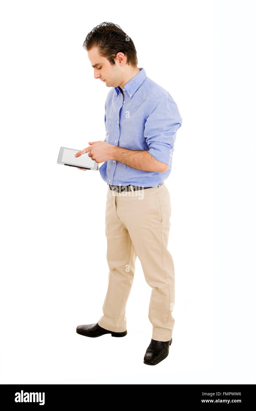 Young man full body using a tablet computer against white background ...