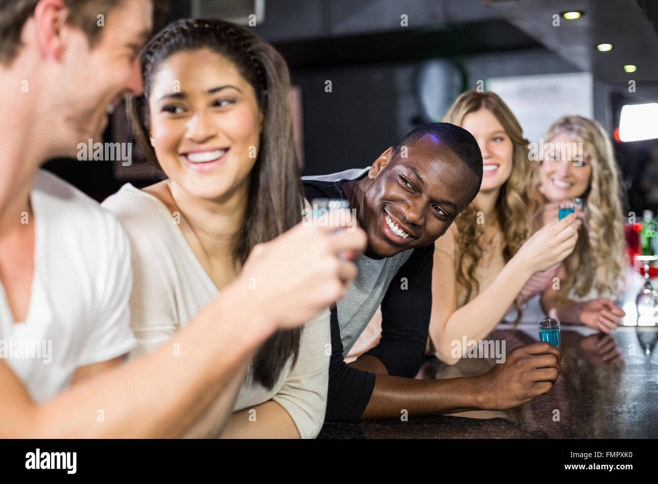 Group of friends having shots Stock Photo - Alamy