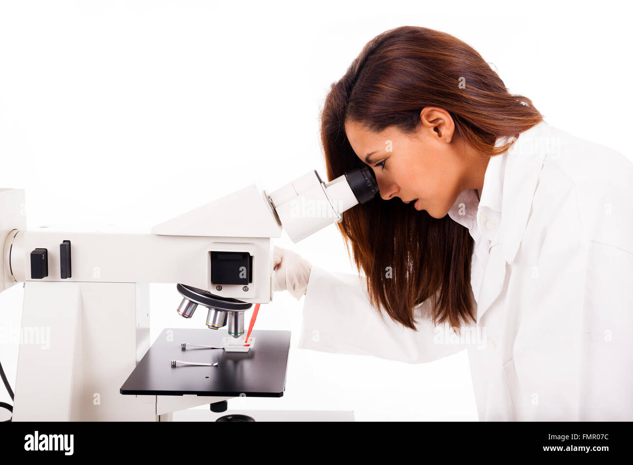 Closeup of a female researcher looking through microscope, isolated on ...