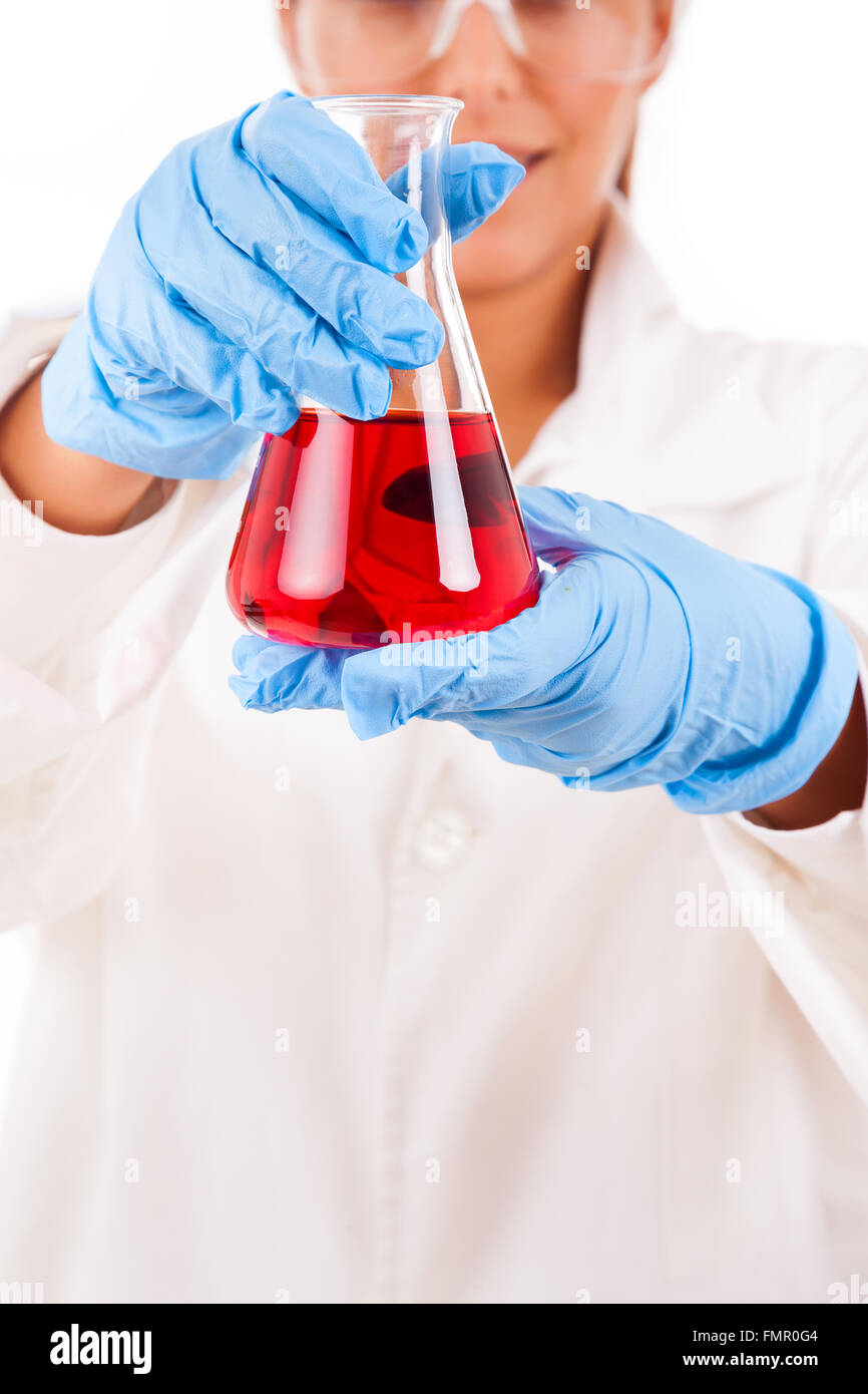 Smiling female scientist holding a beaker of red liquid, isolated on ...