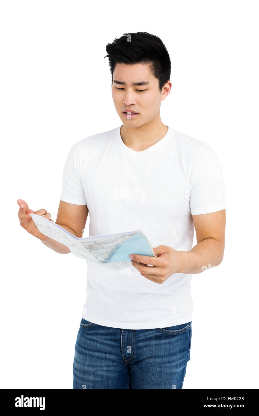Young man looking at map Stock Photo - Alamy