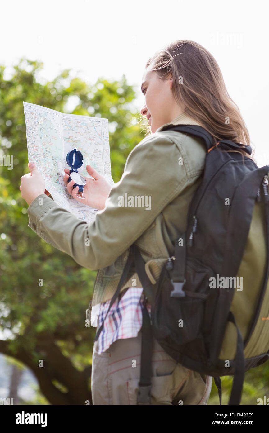 Woman using map and compass Stock Photo - Alamy