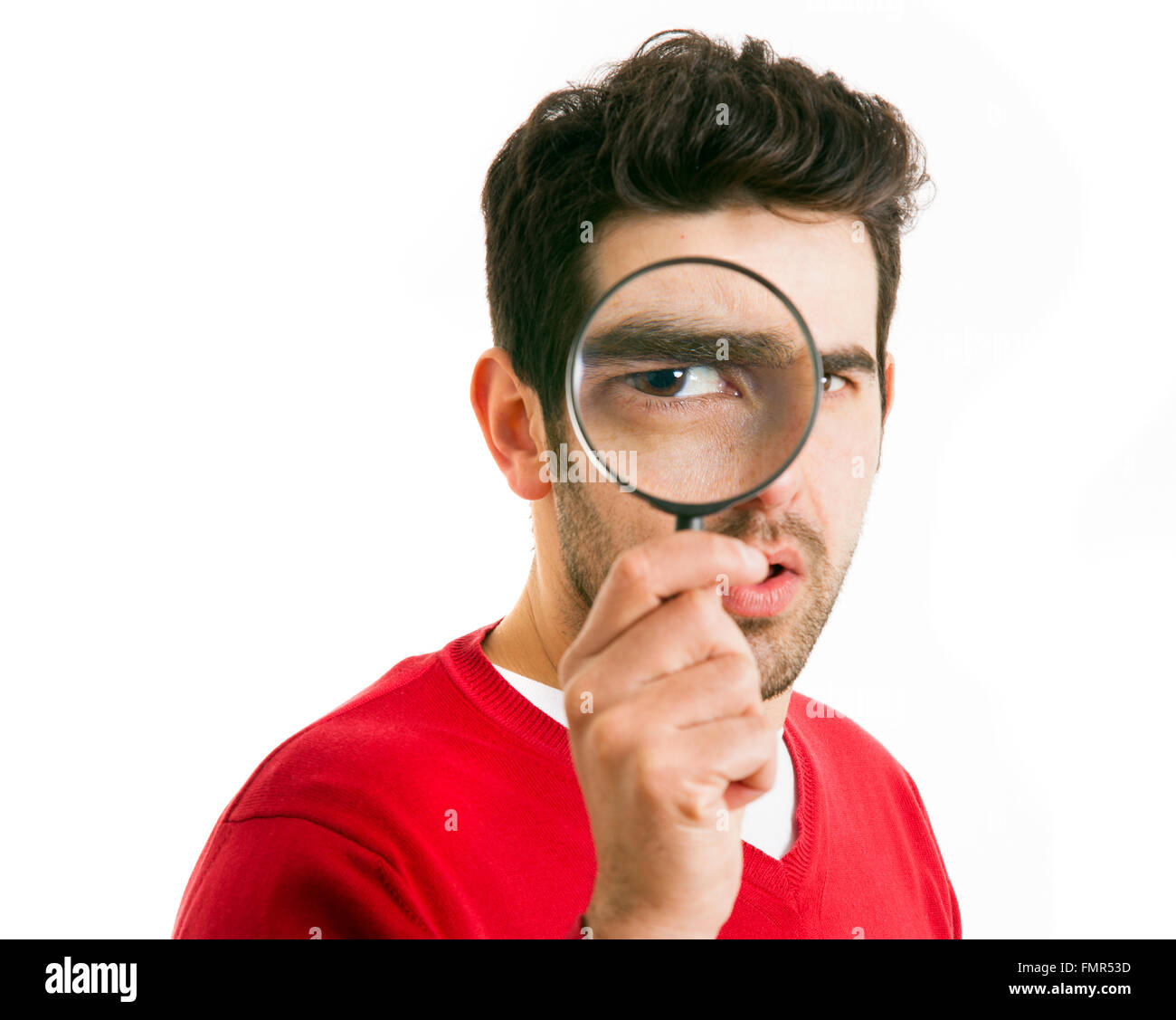 Curious young man looking through magnifying glass, isolated on white ...