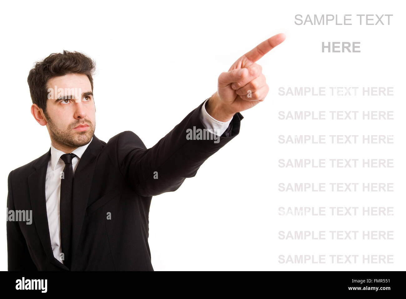 Young business man pointing at something interesting on a white ...