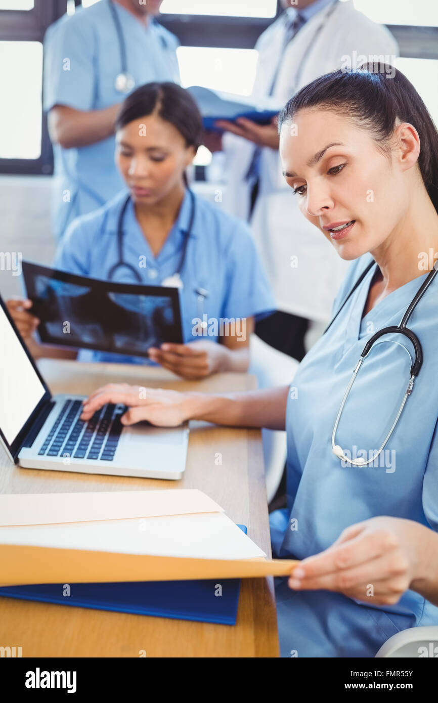 Female doctor looking at medical report Stock Photo - Alamy