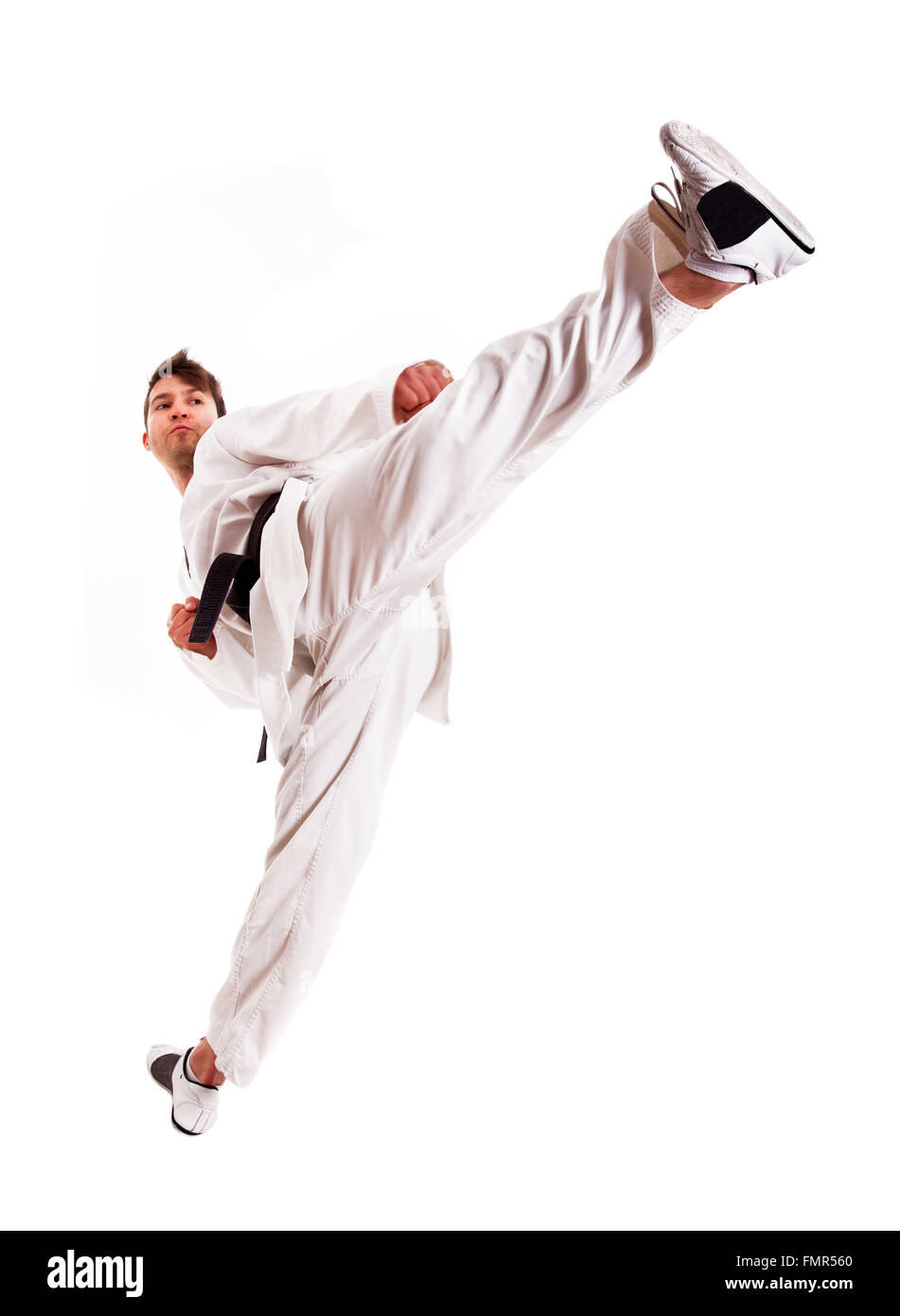Young man practicing martial arts over white background Stock Photo - Alamy
