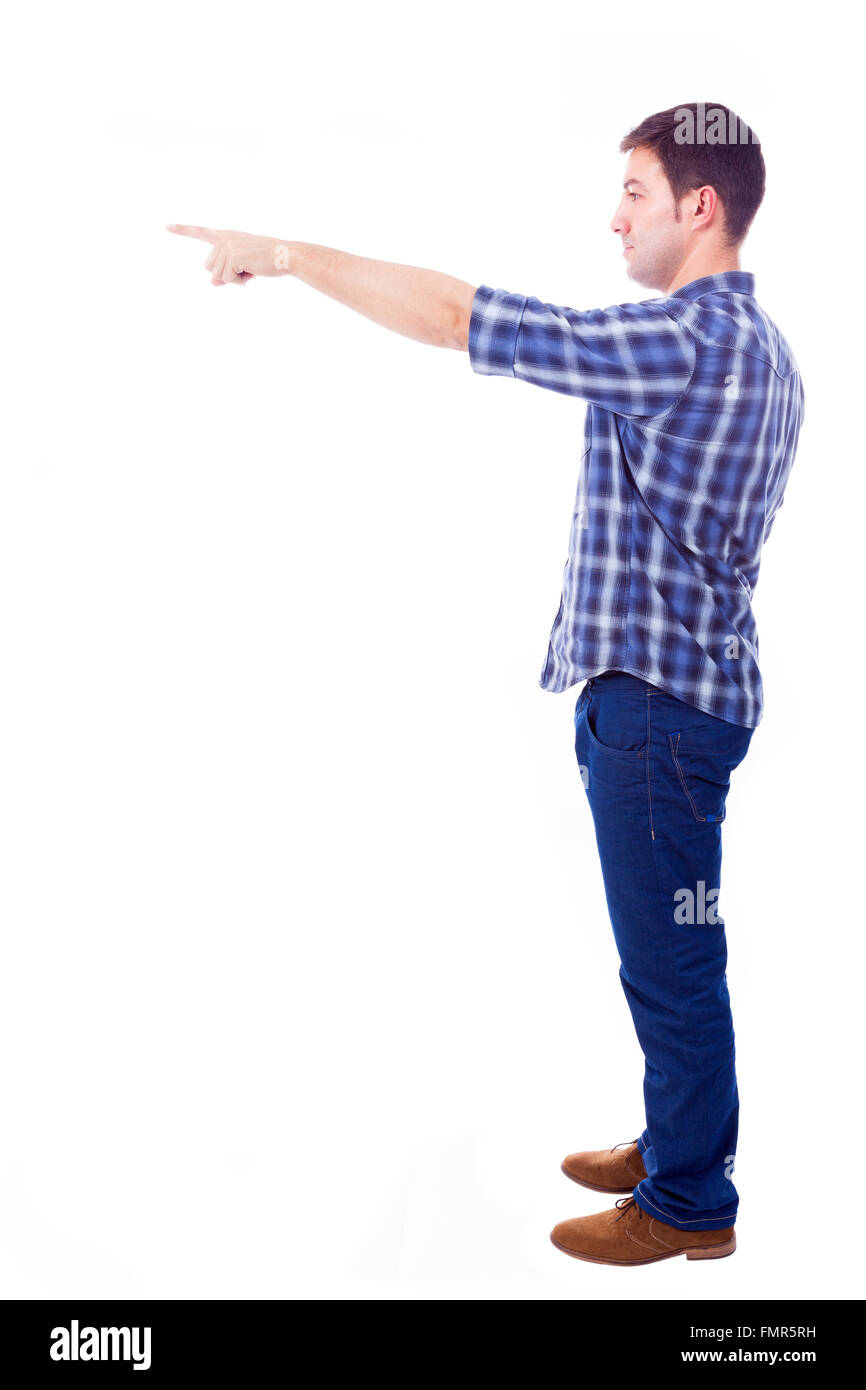 young casual man pointing towards copyspace, isolated on white ...