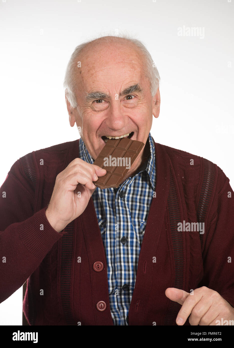 old senior man eating chocolate Stock Photo - Alamy