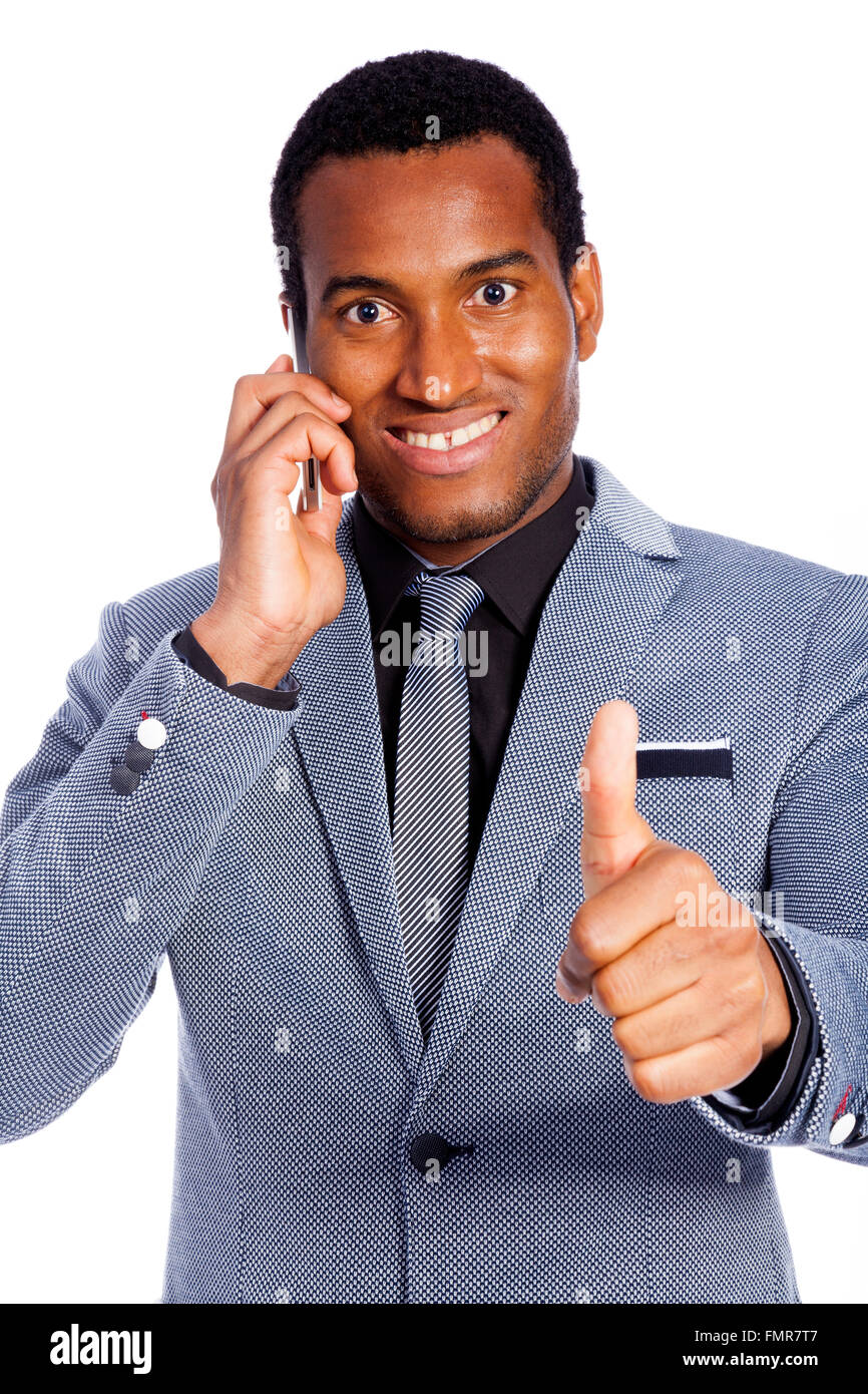 Happy smiling young business man talking on the phone and gesturing ...