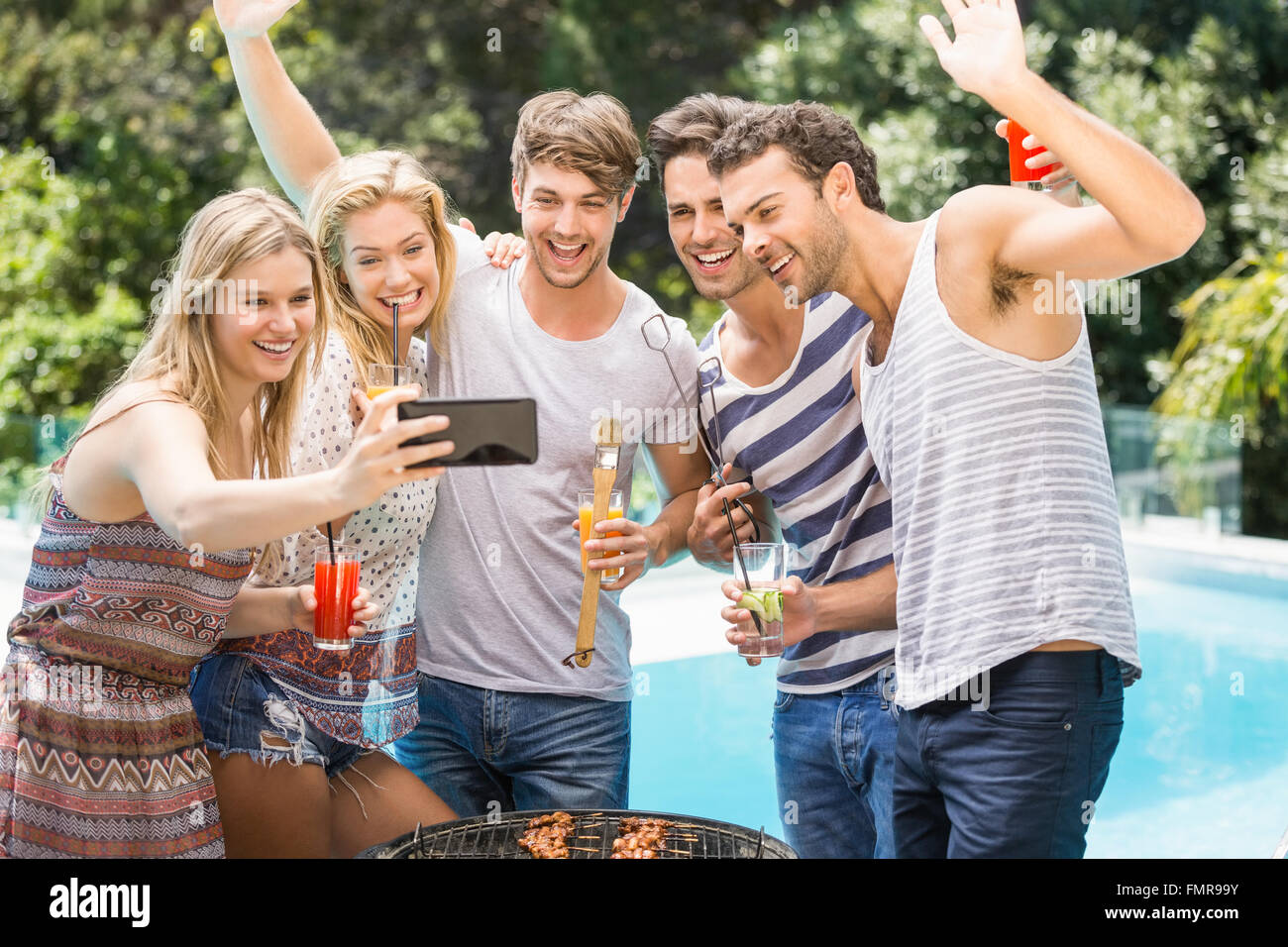 Group of friends taking a selfie near pool Stock Photo - Alamy
