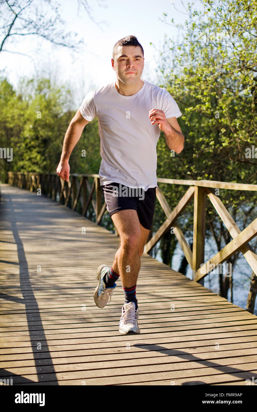 Young healthy man running at the park Stock Photo - Alamy