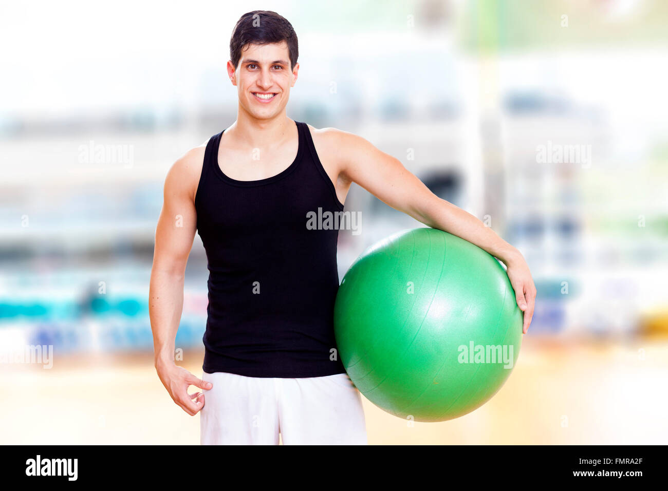 Young athletic man exercising workout fitness ball at the gym Stock ...