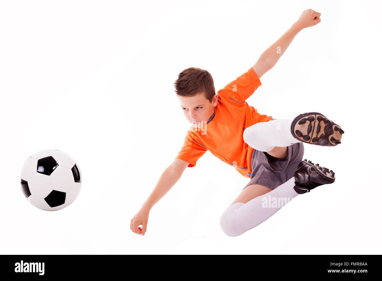 Boy making a acrobatic kick with soccer ball, isolated on white ...