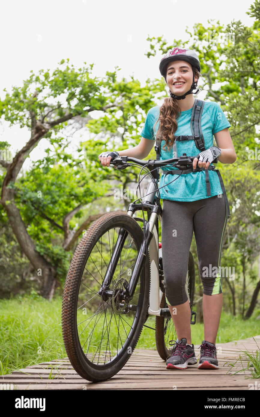 Woman pushing her bike Stock Photo - Alamy