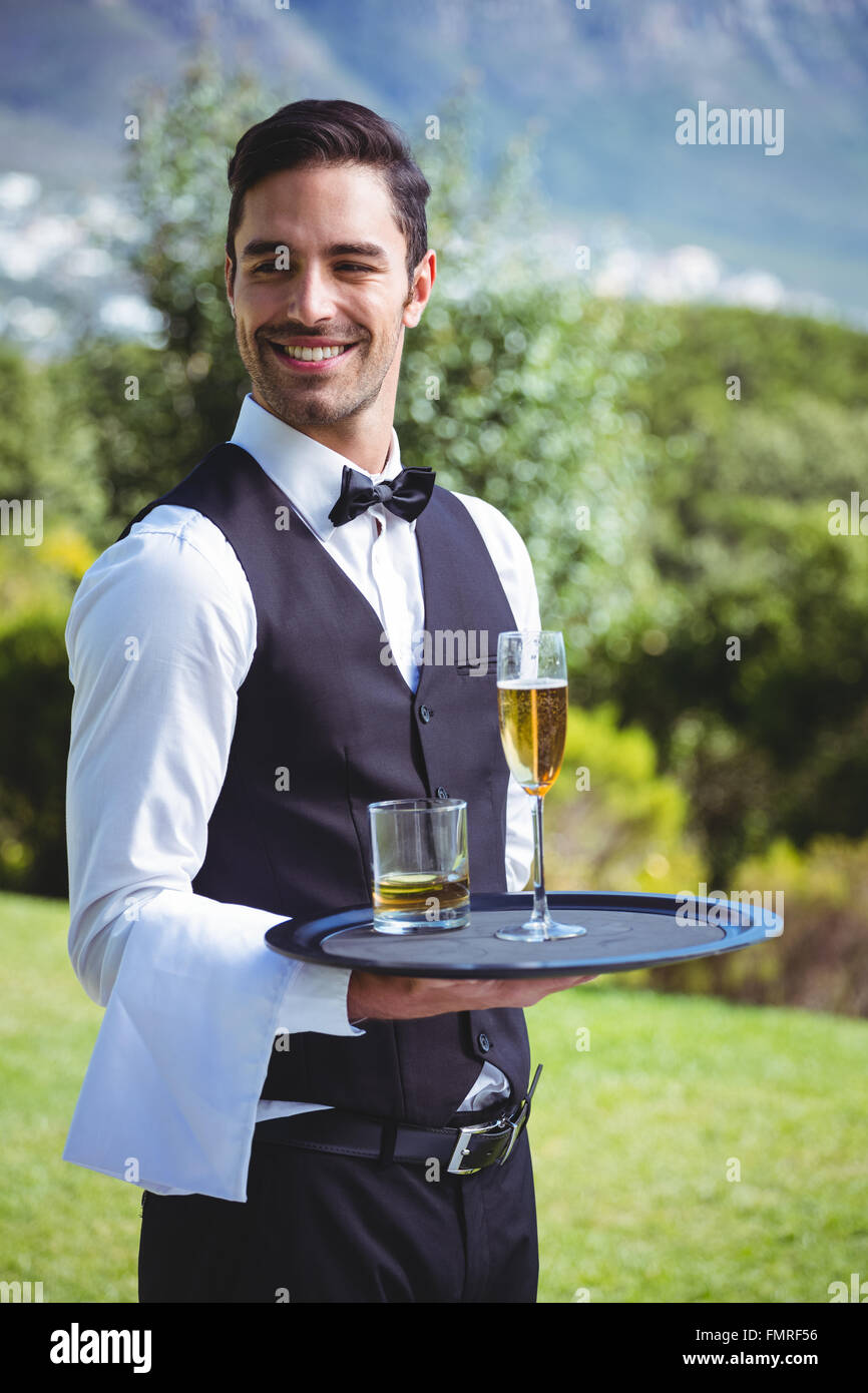 Handsome waiter holding a tray with drinks Stock Photo - Alamy Handsome waiter holding a tray with drinks Stock Photo - Alamy