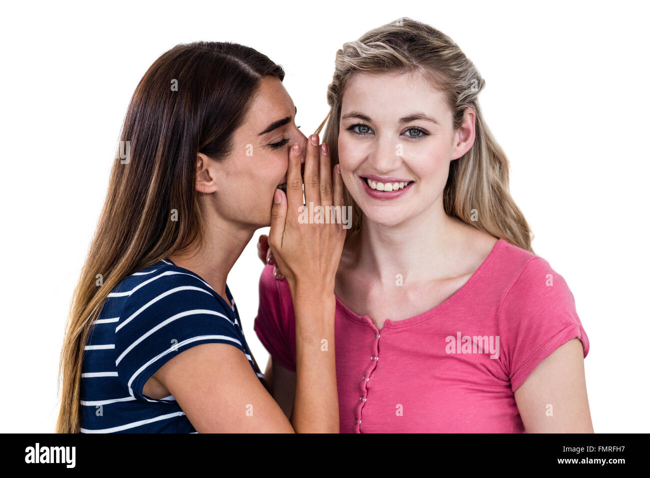 Woman telling secret to friend Stock Photo - Alamy
