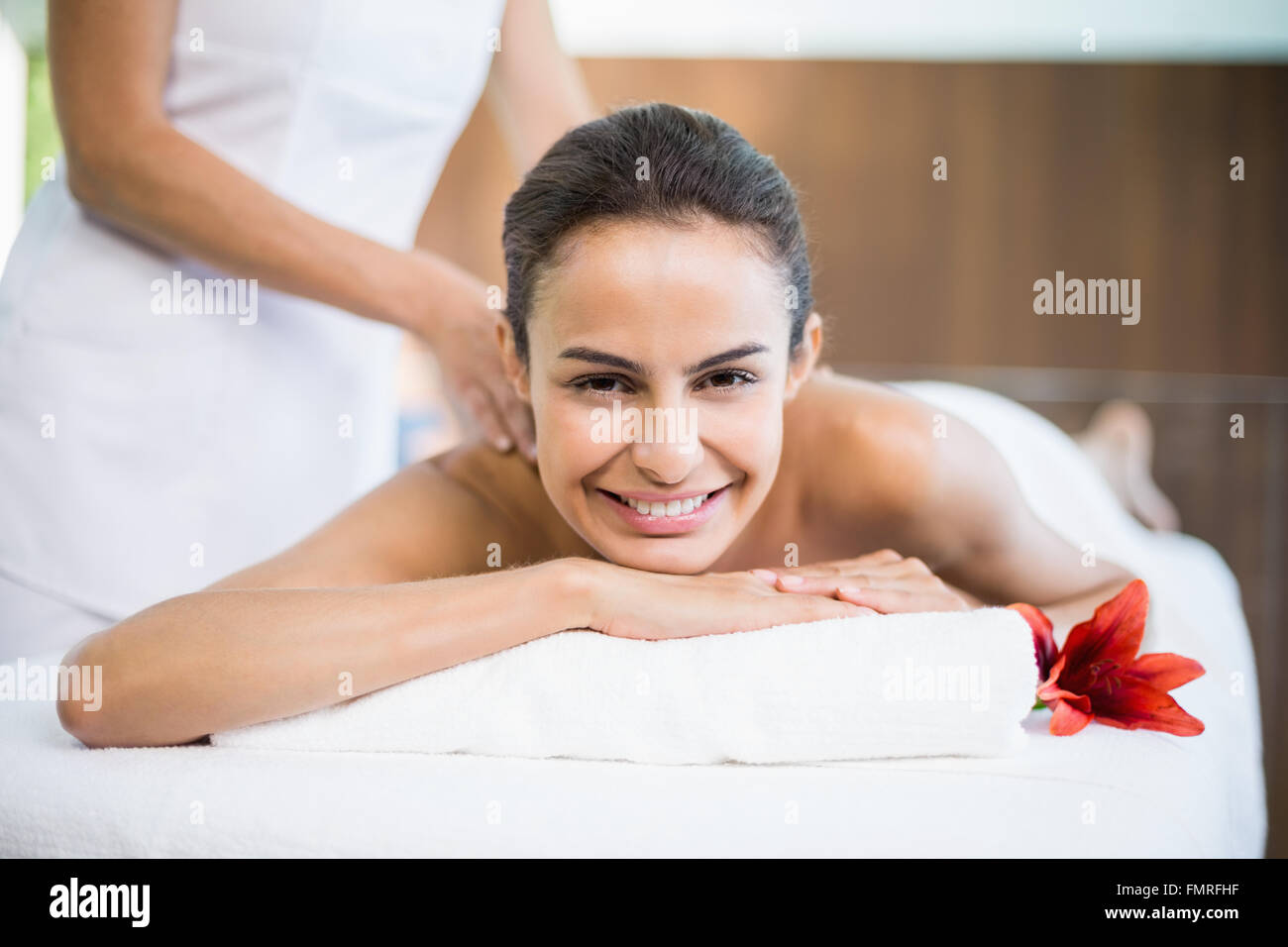 Portrait of young woman smiling while receiving massage Stock Photo - Alamy