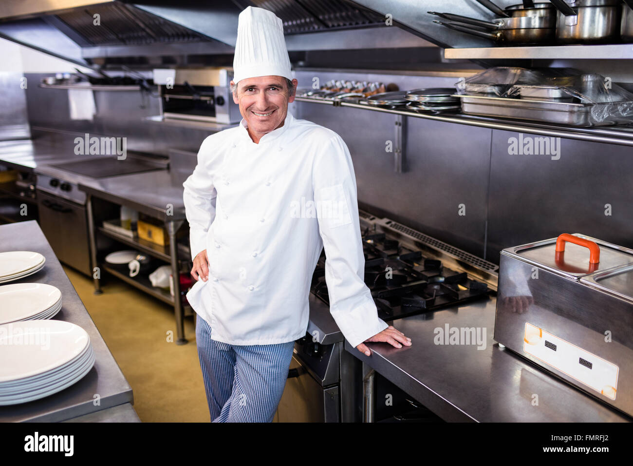 Happy male chef standing in commercial kitchen Stock Photo - Alamy