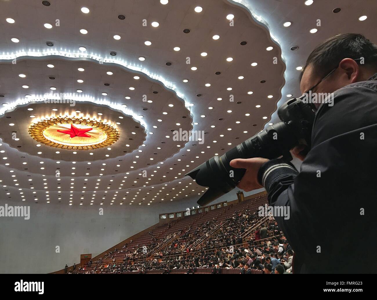 Beijing, China. 13th Mar, 2016. A photographer works during the third ...