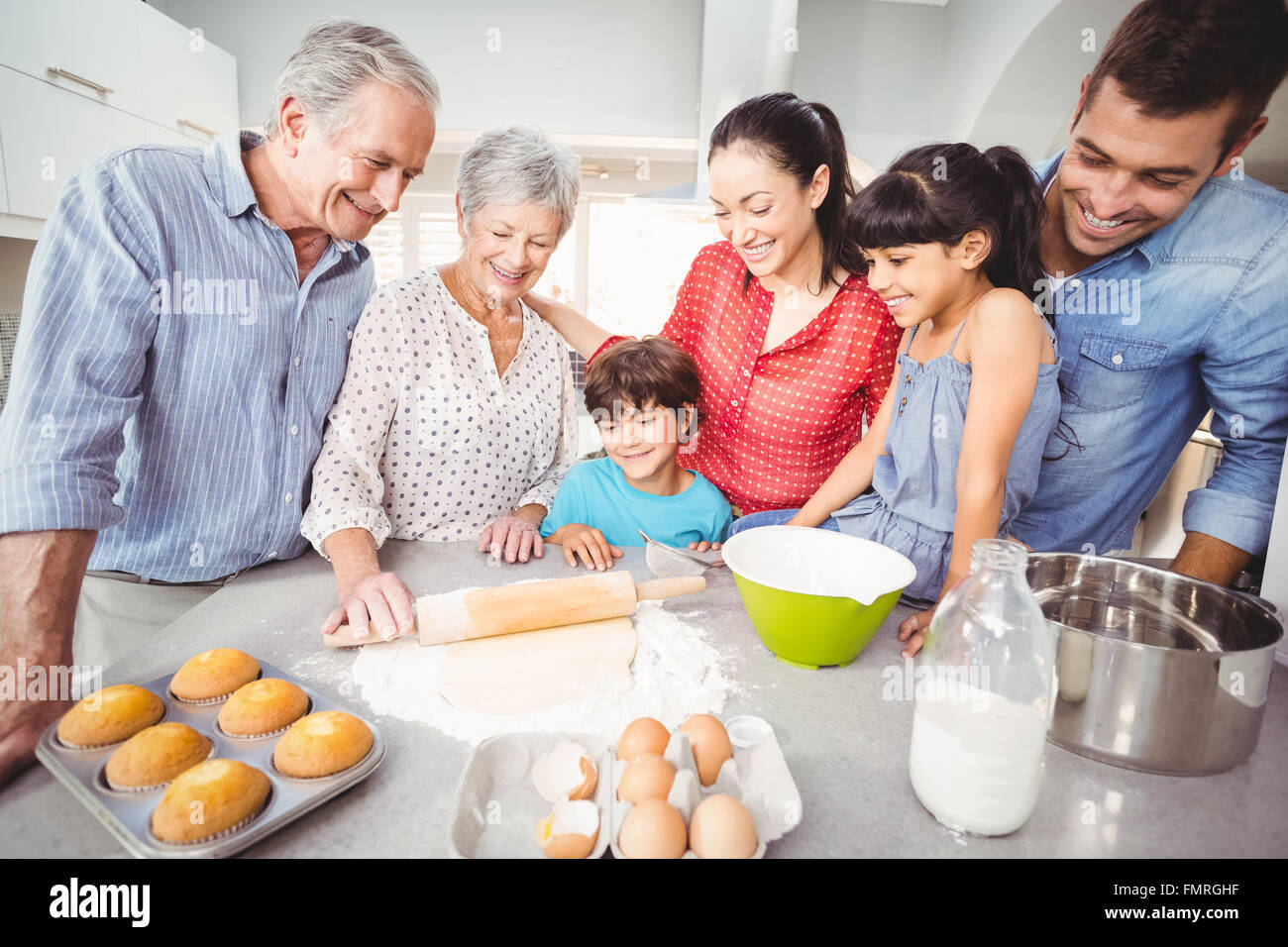Happy family making bread in kitchen Stock Photo - Alamy