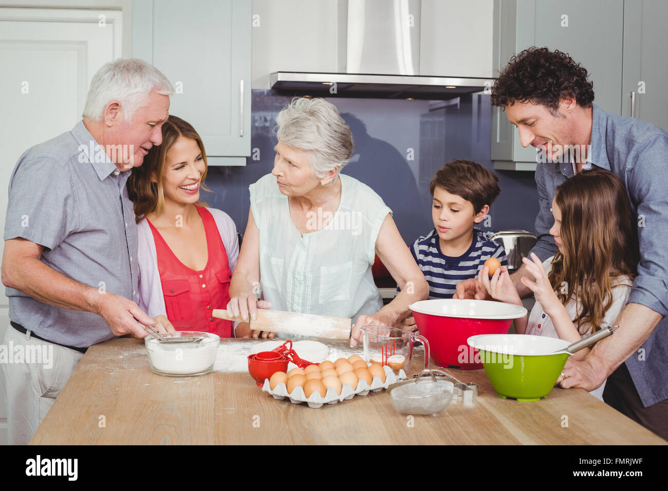 Happy family cooking food in kitchen Stock Photo - Alamy