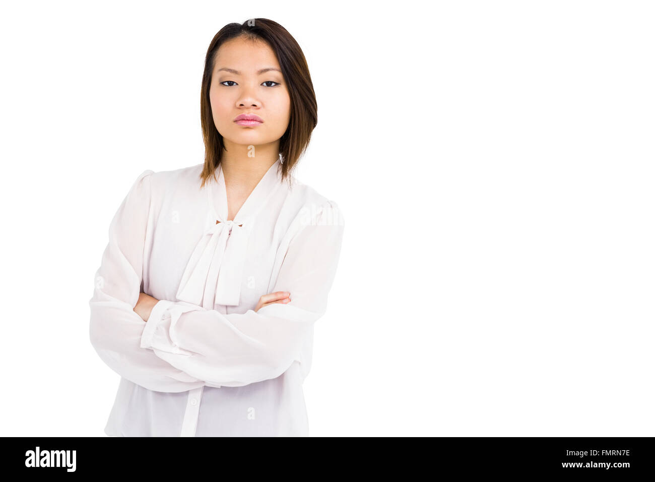 Angry young woman standing with arms crossed Stock Photo - Alamy