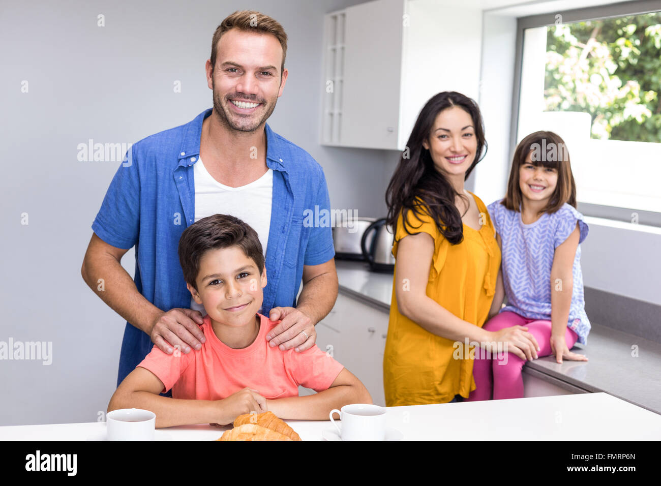 Happy family in kitchen Stock Photo - Alamy