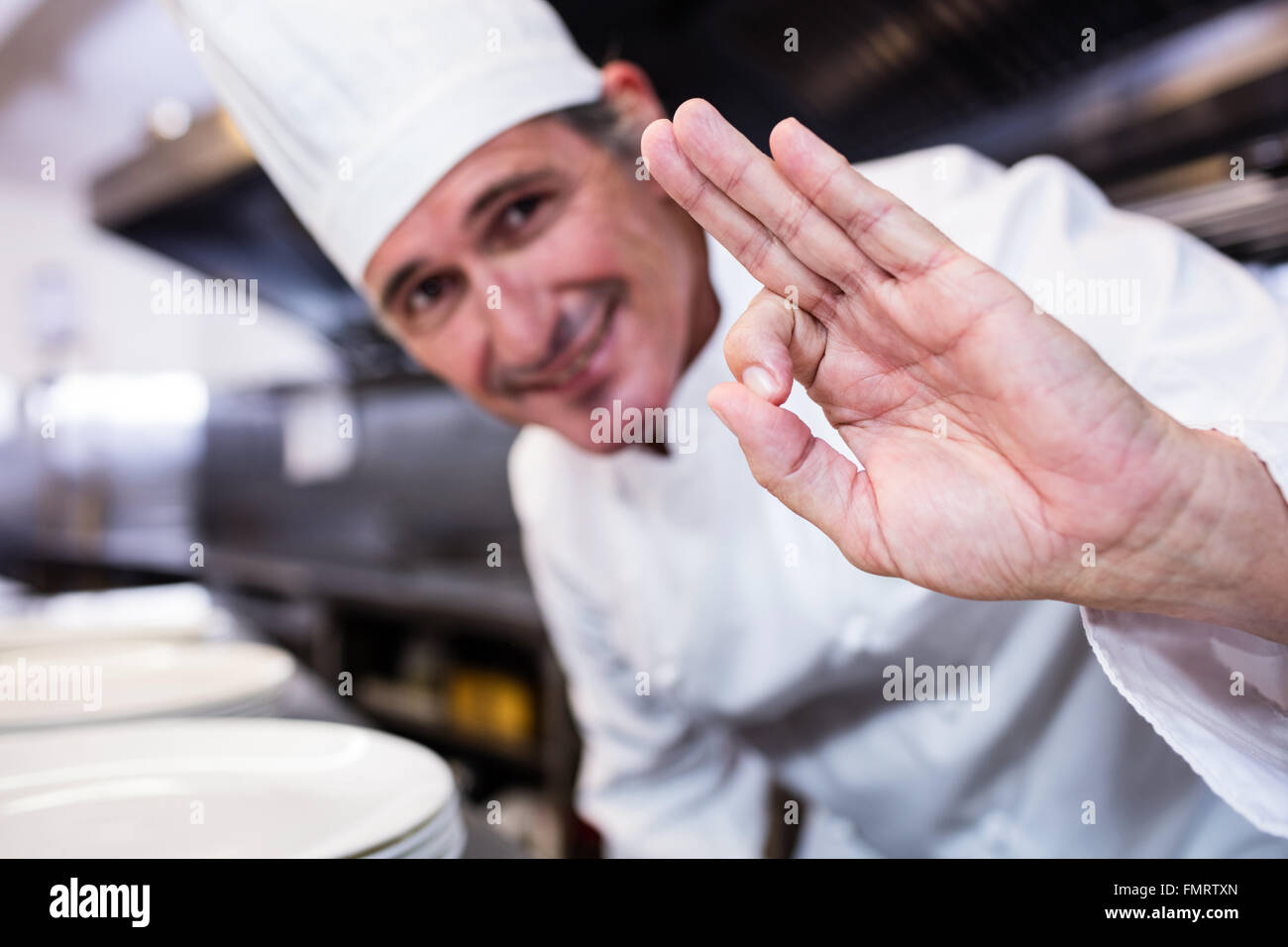 Smiling chef showing ok sign Stock Photo - Alamy