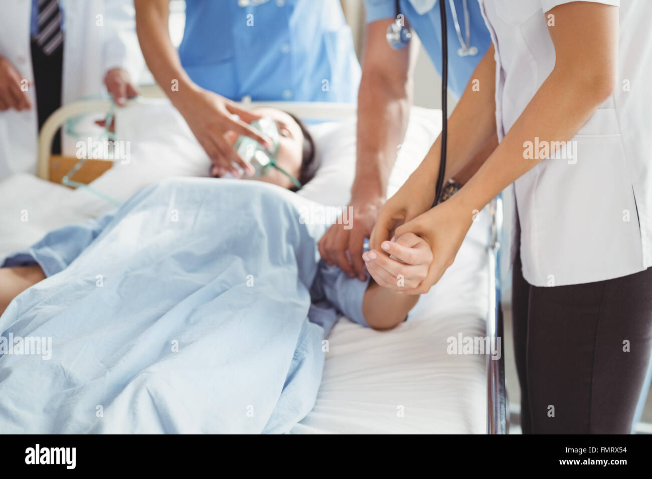 Doctor checking female patient pulse Stock Photo - Alamy