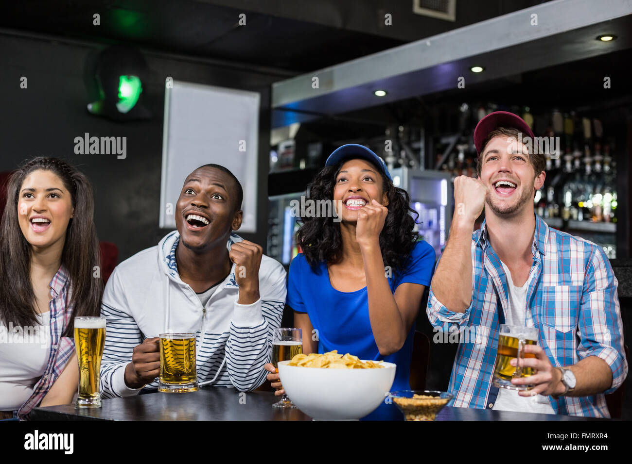 Happy friends watching sport Stock Photo - Alamy