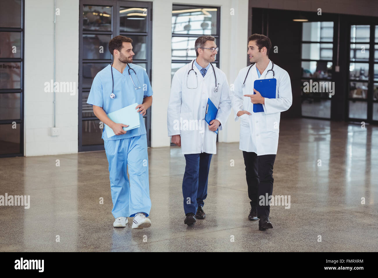Full length of doctors discussing Stock Photo - Alamy