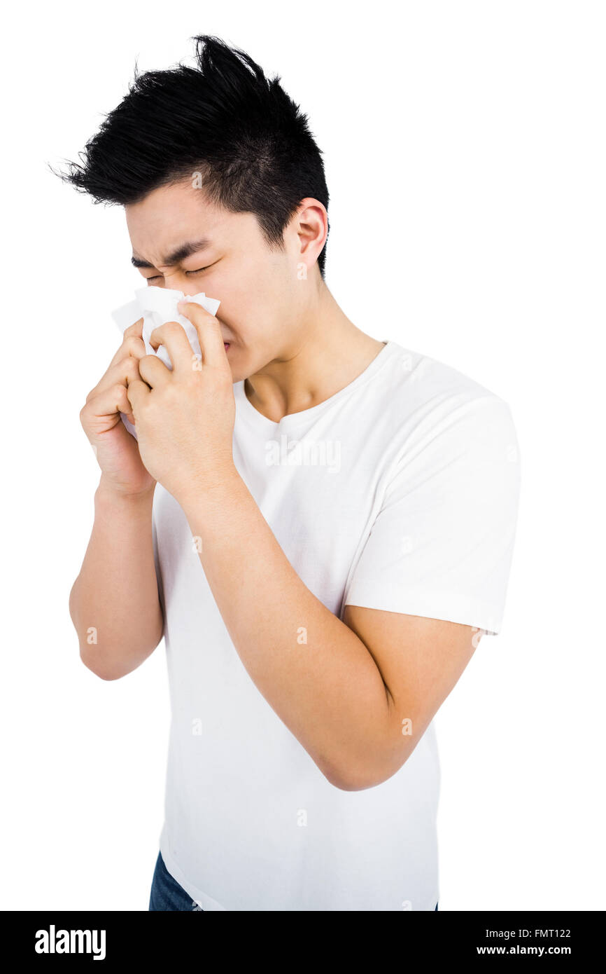 Young man wiping his nose Stock Photo - Alamy