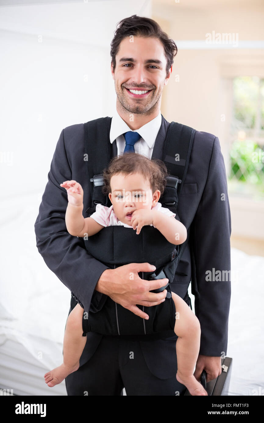 Portrait of smiling father carrying baby Stock Photo - Alamy