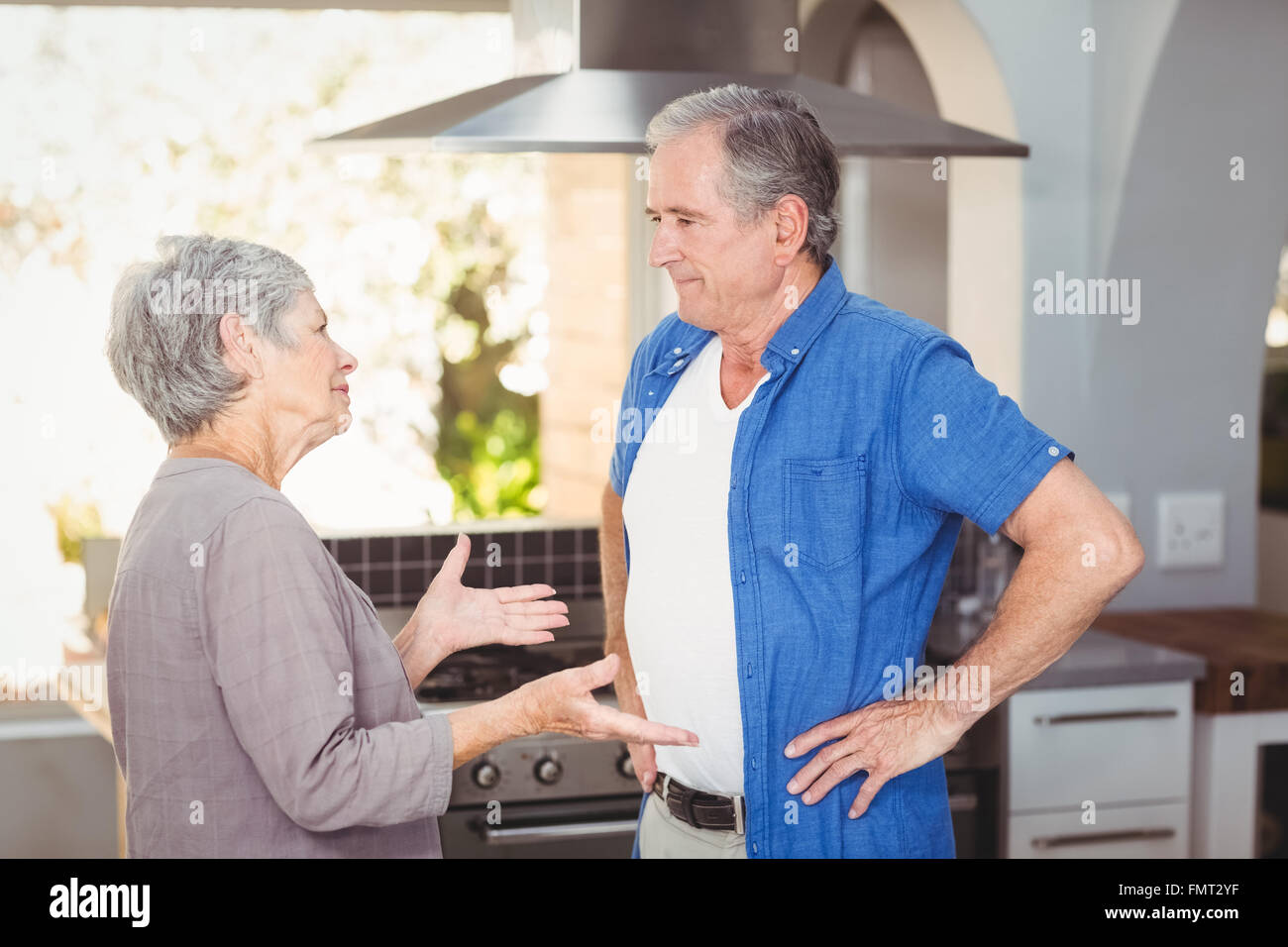 Side view of senior couple arguing in kitchen Stock Photo - Alamy