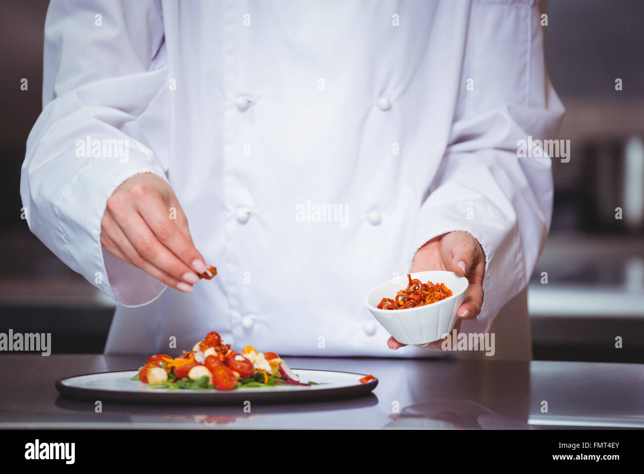 Chef sprinkling spices on dish Stock Photo - Alamy