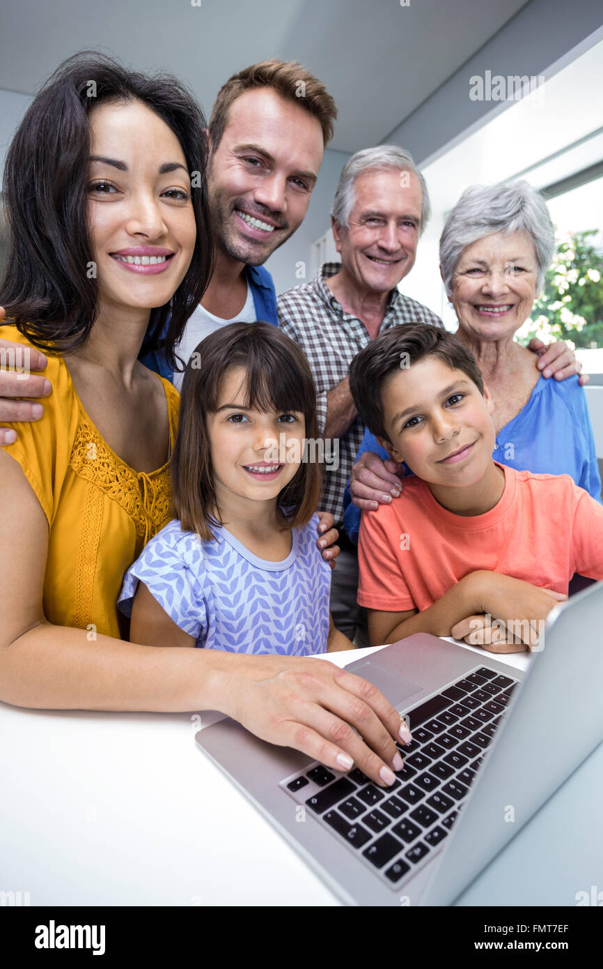 Happy family interacting using laptop Stock Photo - Alamy