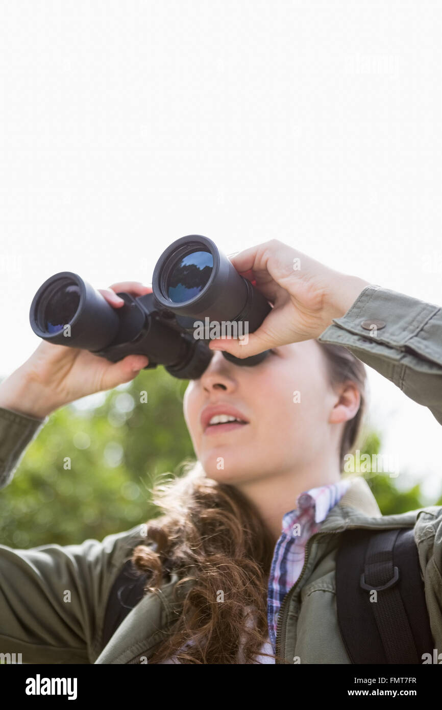 Woman using binoculars Stock Photo - Alamy
