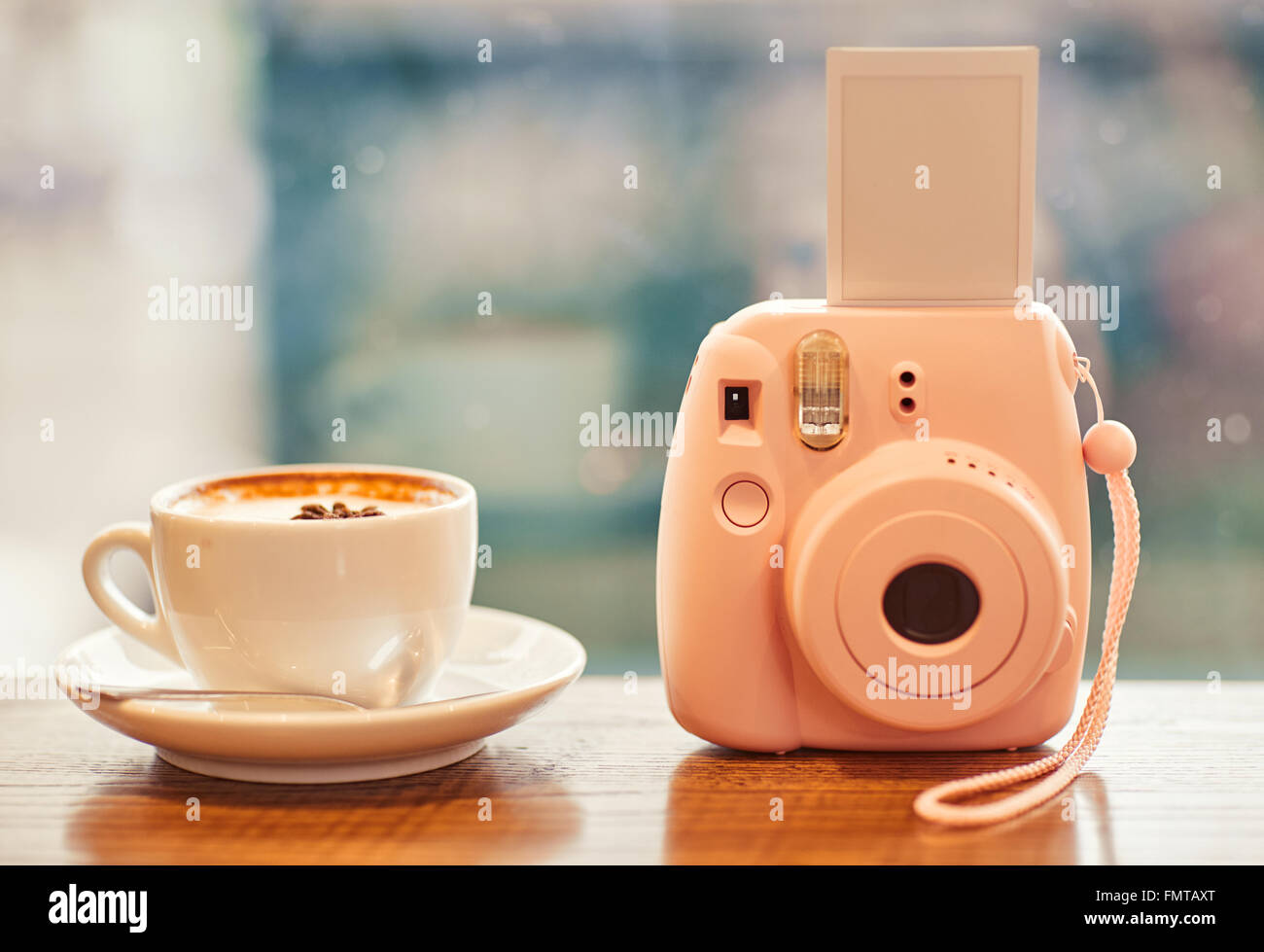 Photo camera standing on the table near cup of coffee Stock Photo - Alamy
