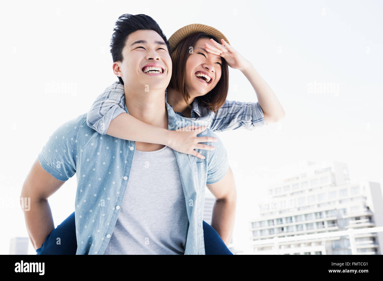 Young man giving a piggyback ride to woman Stock Photo - Alamy