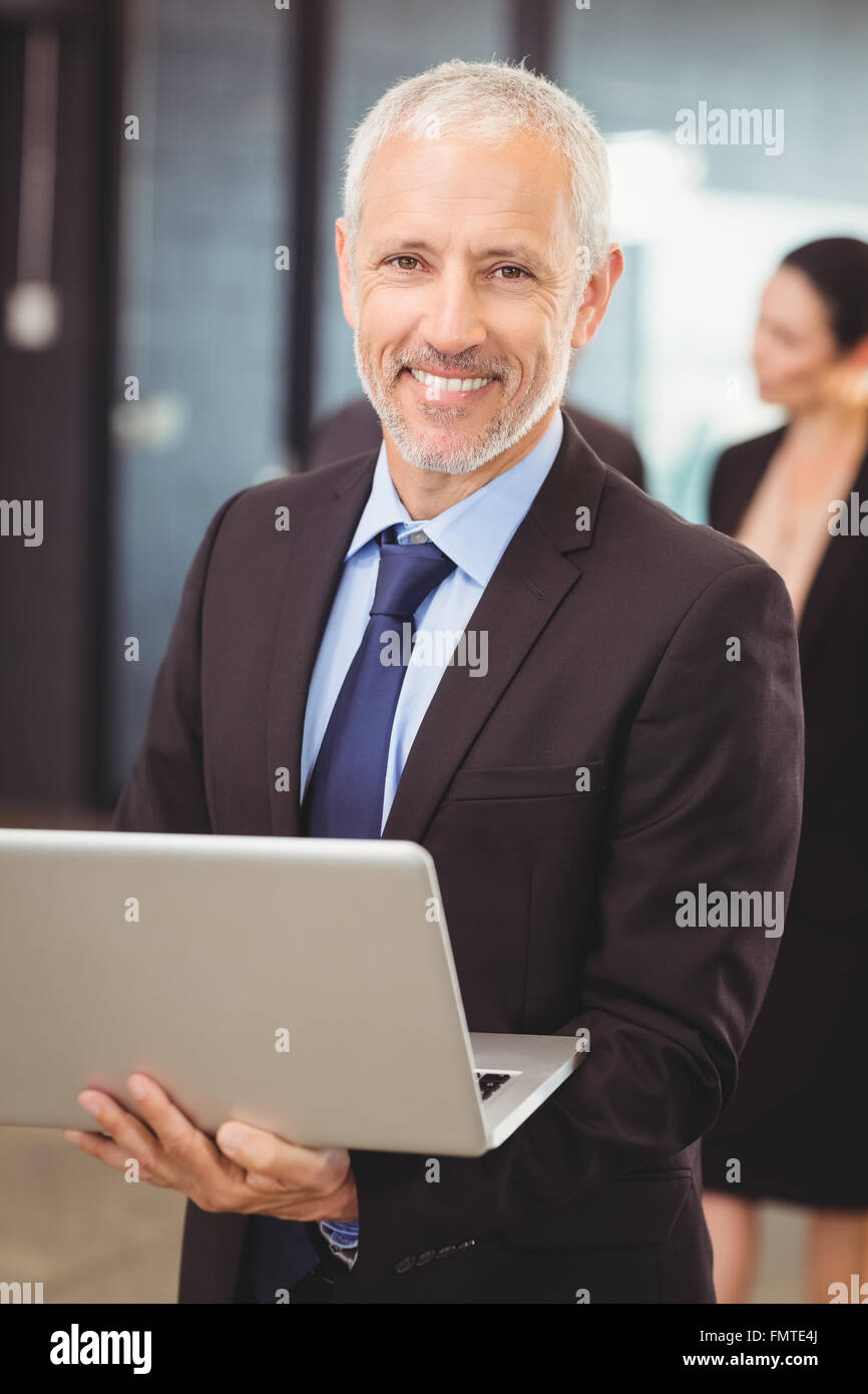 Businessman using laptop in office Stock Photo - Alamy