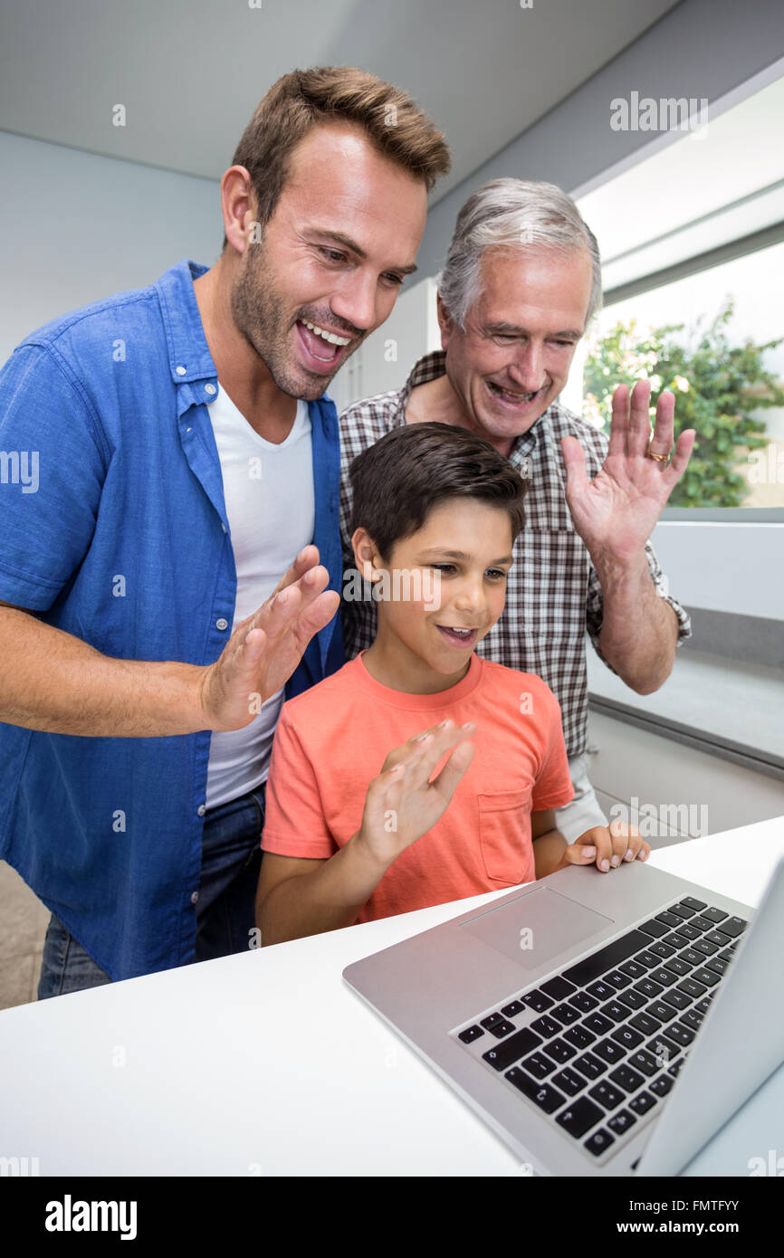 Happy family interacting using laptop Stock Photo - Alamy