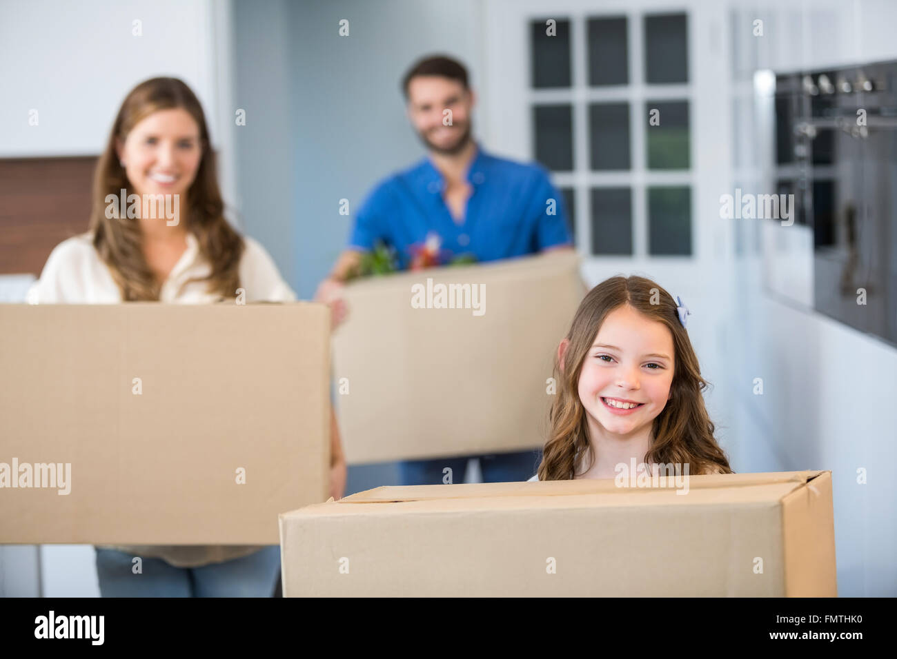 Portrait of family holding boxes Stock Photo - Alamy