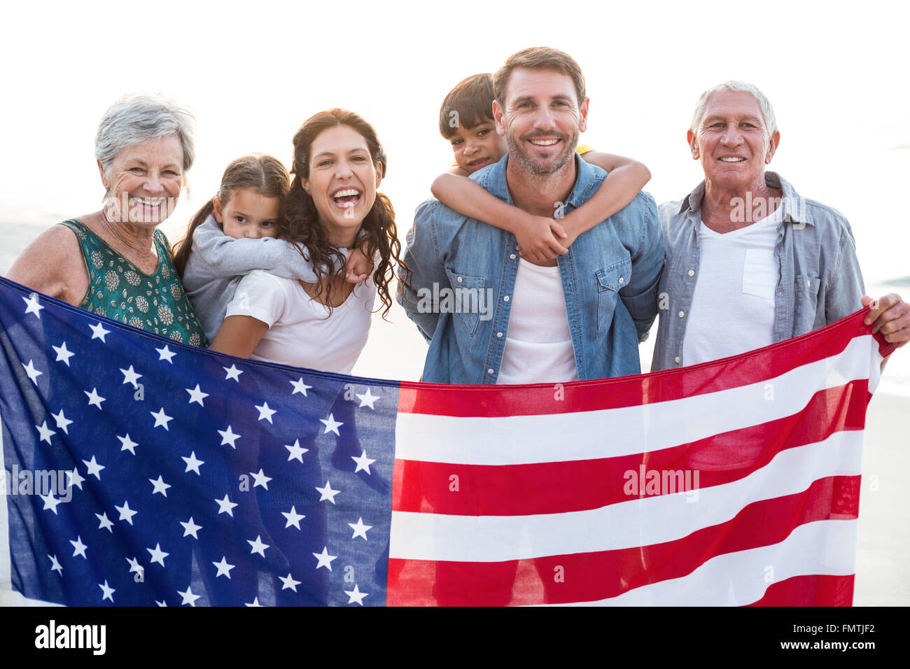 Happy family with an american flag Stock Photo - Alamy