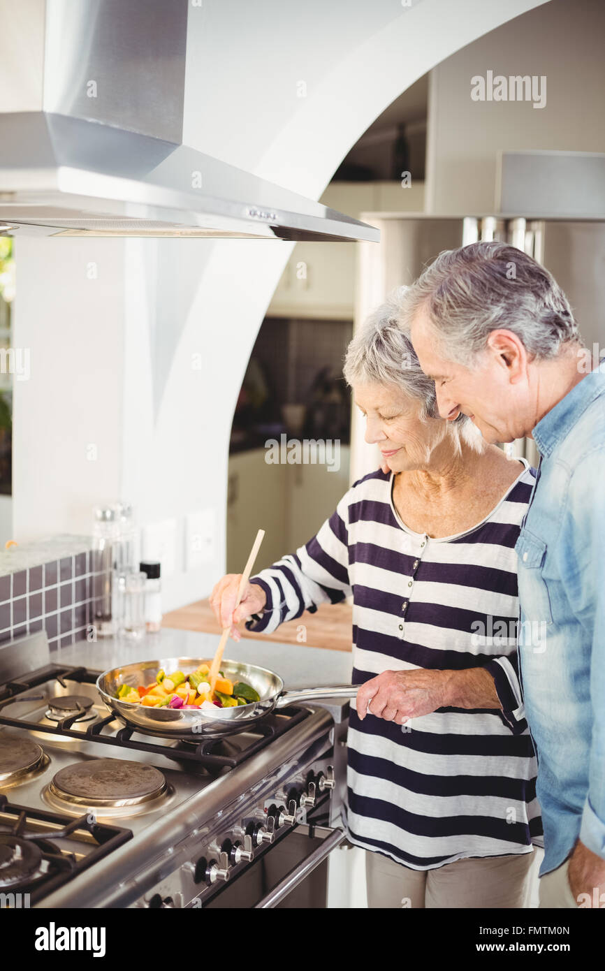 Senior couple cooking food in kitchen Stock Photo - Alamy