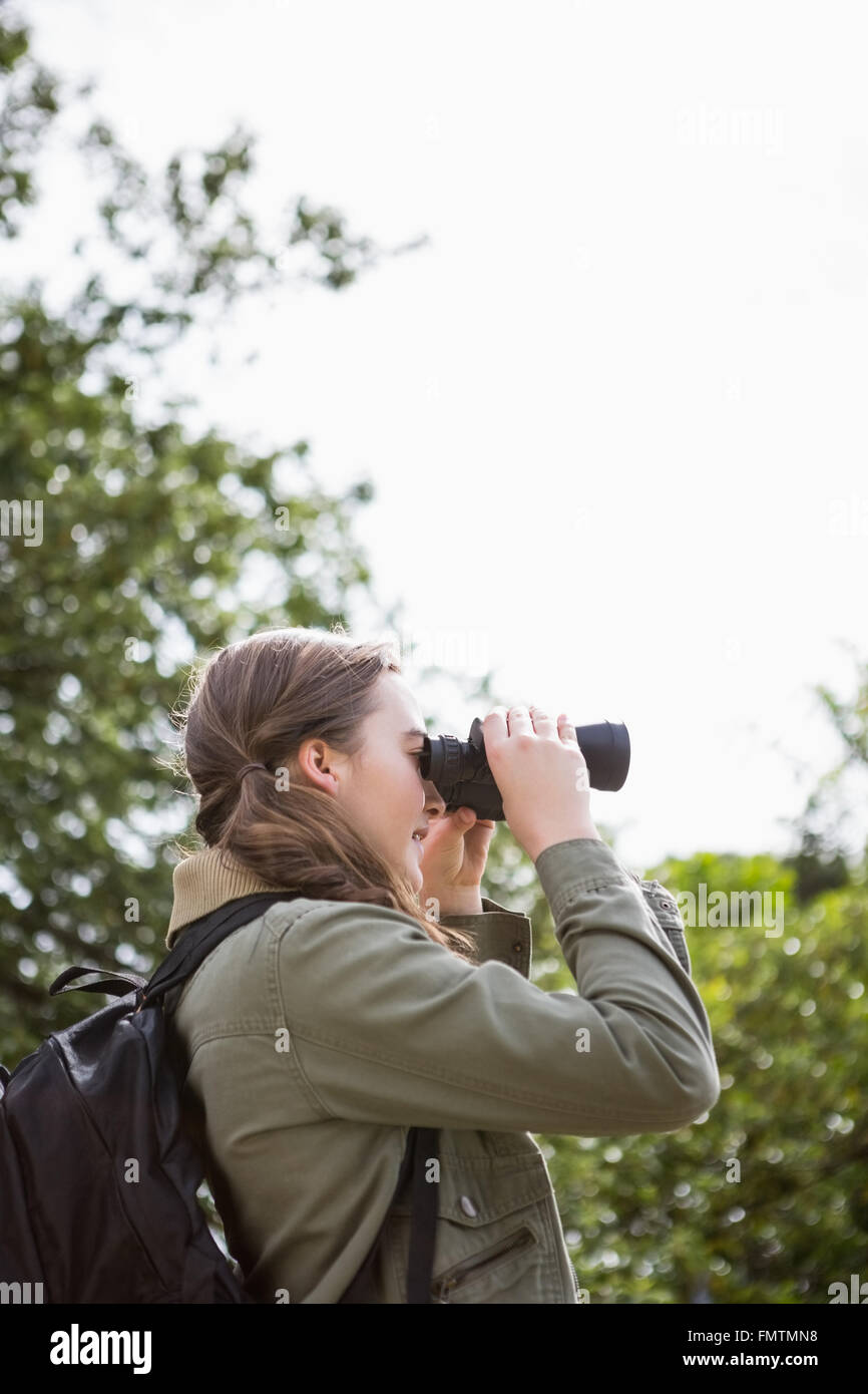 Woman using binoculars Stock Photo - Alamy