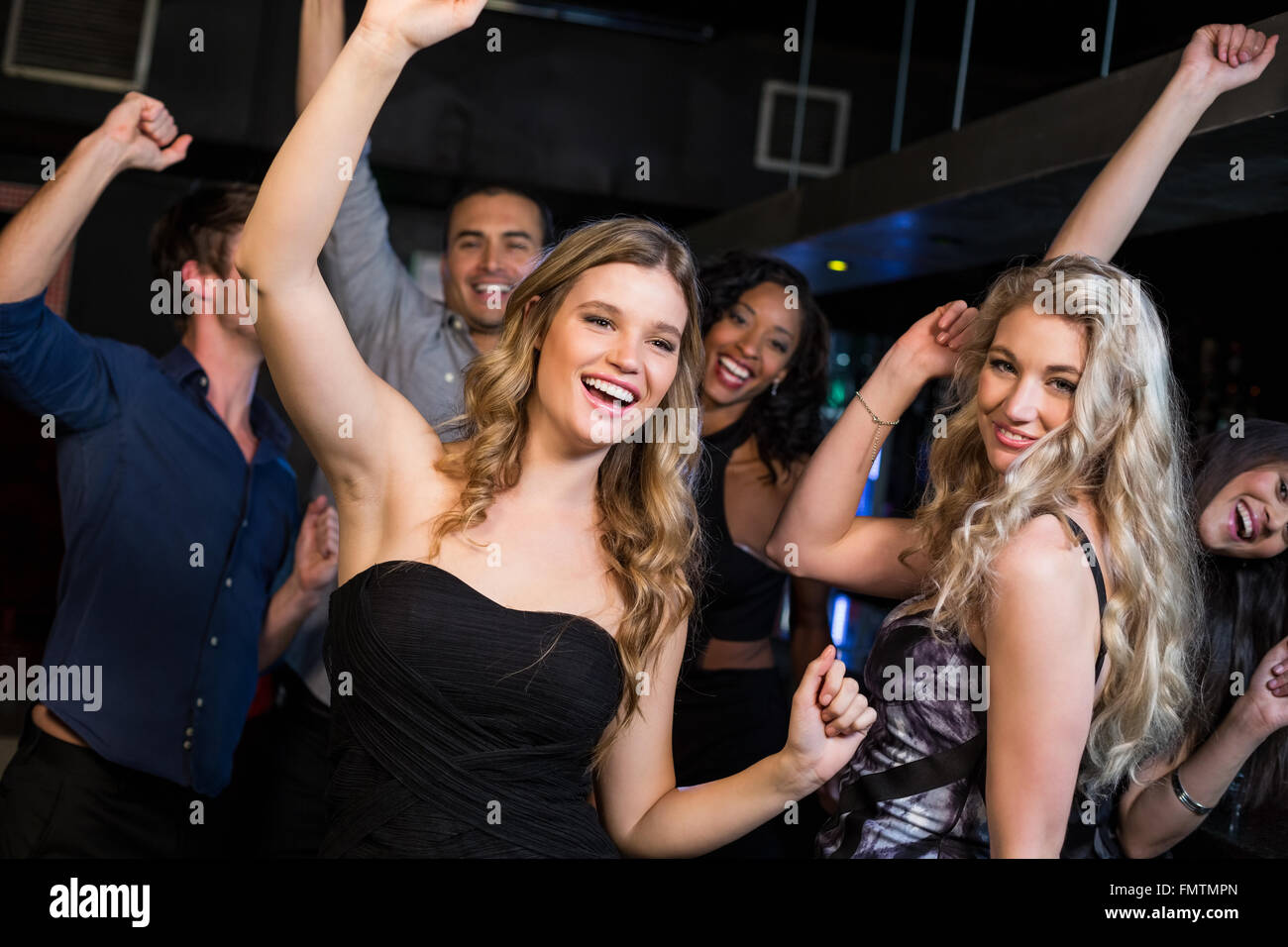Happy friends dancing together Stock Photo - Alamy