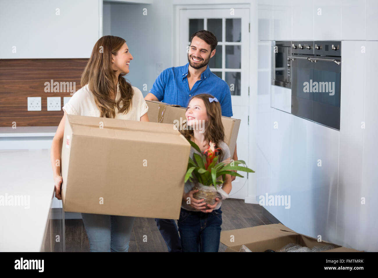 Happy family holding boxes Stock Photo - Alamy