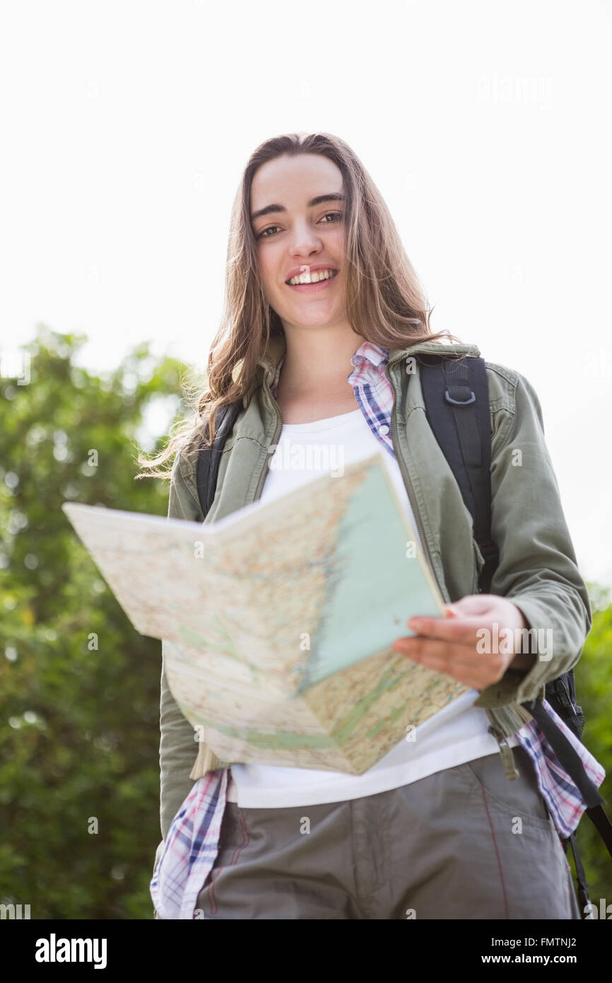 Smiling woman checking the map Stock Photo - Alamy