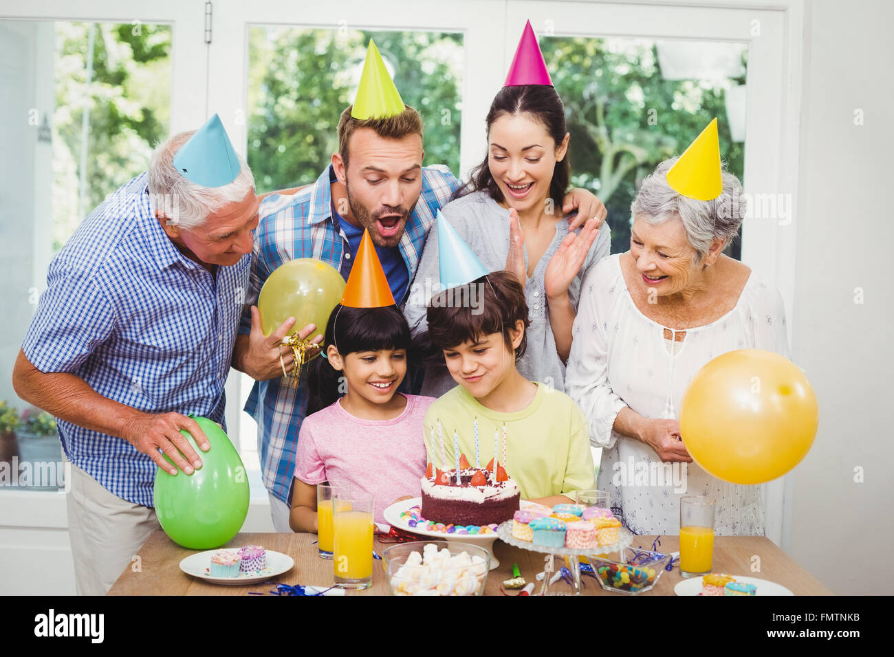 Smiling family during birthday party Stock Photo - Alamy
