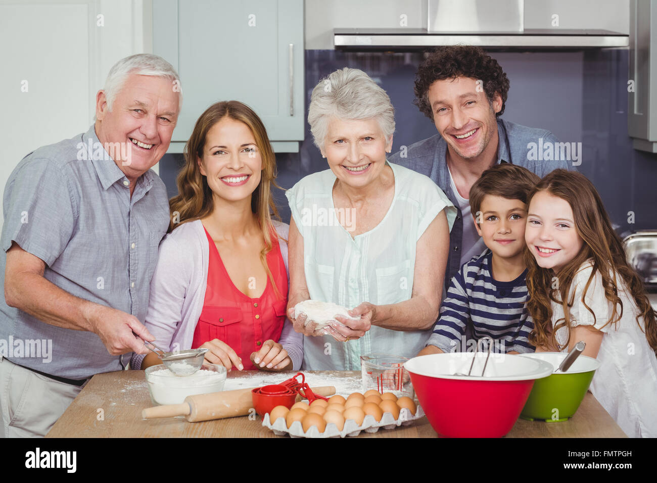 Portrait of happy family cooking food in kitchen Stock Photo - Alamy